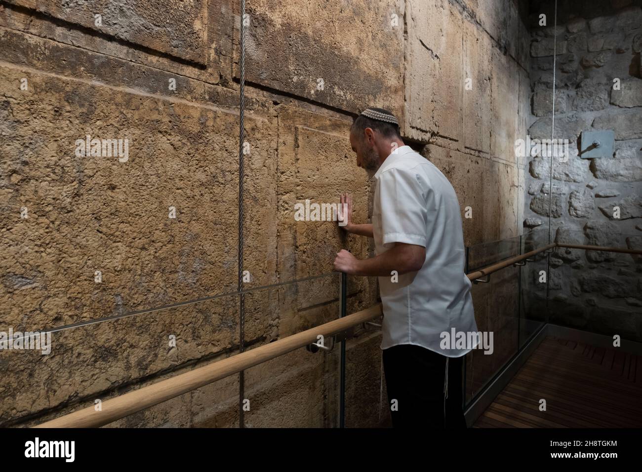 A religious Jew prays in front of recently excavated large portions of ...