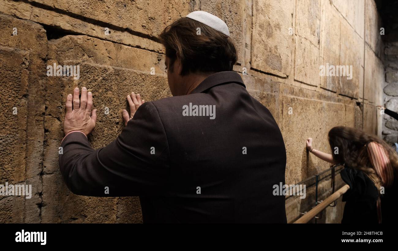 A religious Jew prays in front of recently excavated large portions of ...
