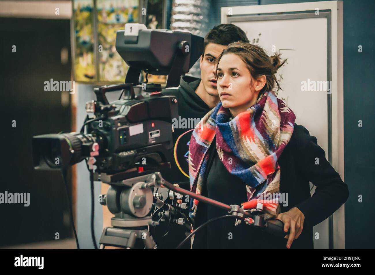 Behind the scene. Cameraman and assistant shooting the film scene with ...