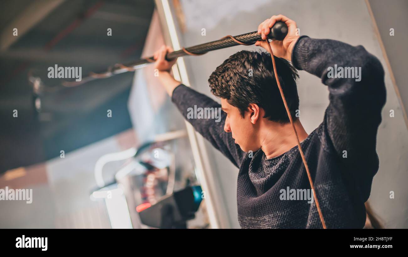 Behind the scene. Sound boom operator hold microphone fisher on the set ...