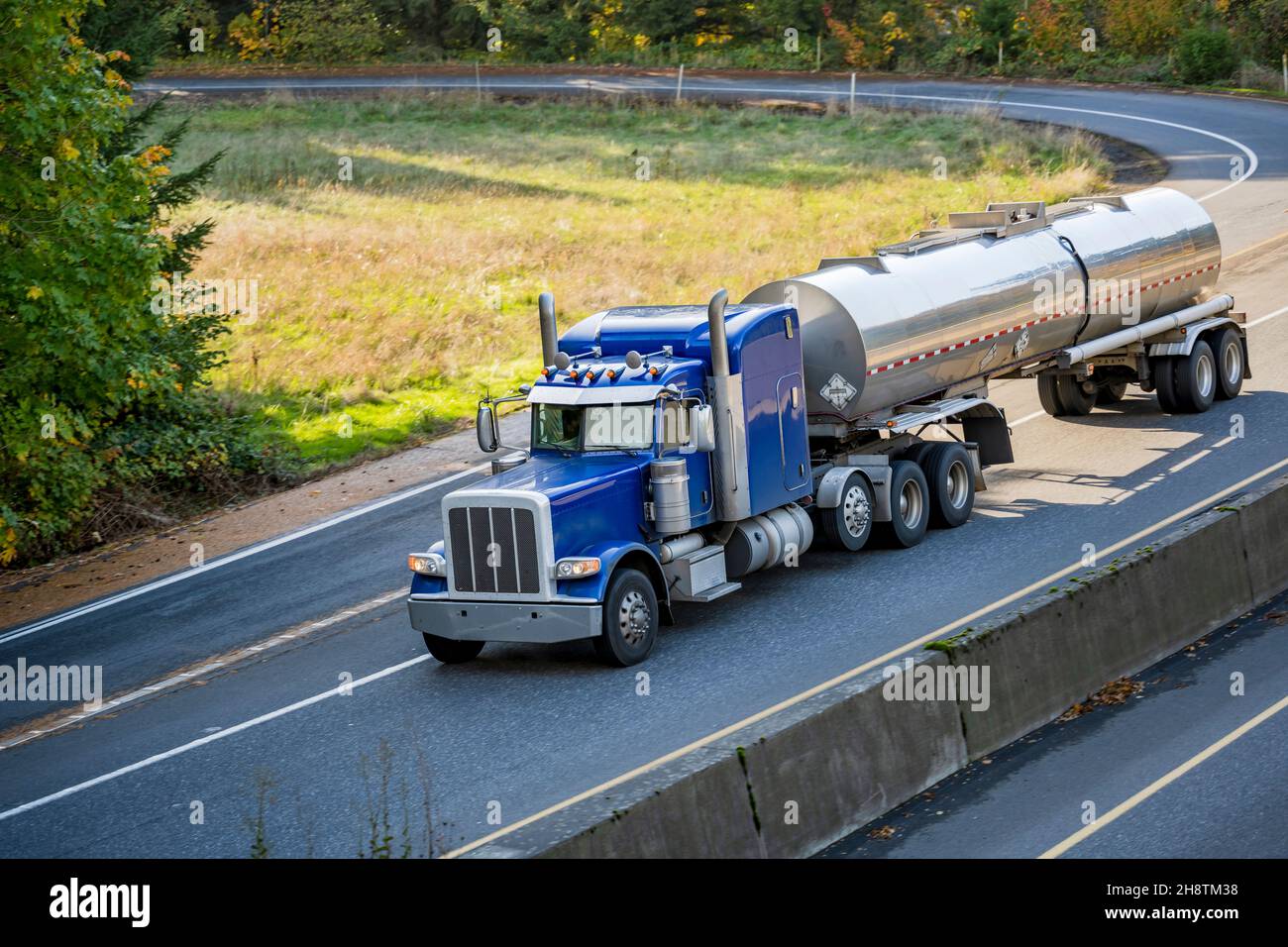 Industrial big rig blue semi truck tractor transporting commercial ...