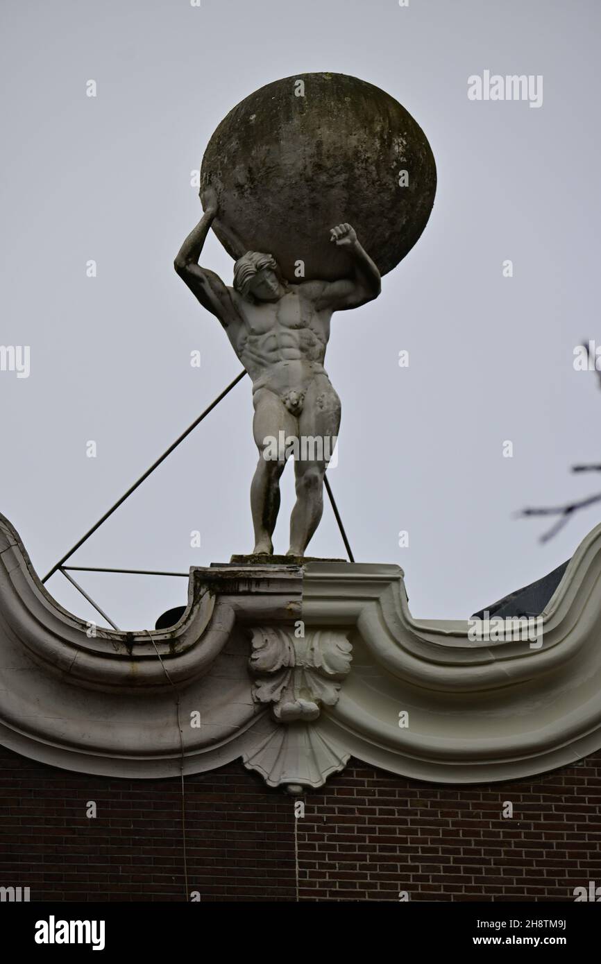 Ancient male sculpture lifting a huge ball Stock Photo - Alamy