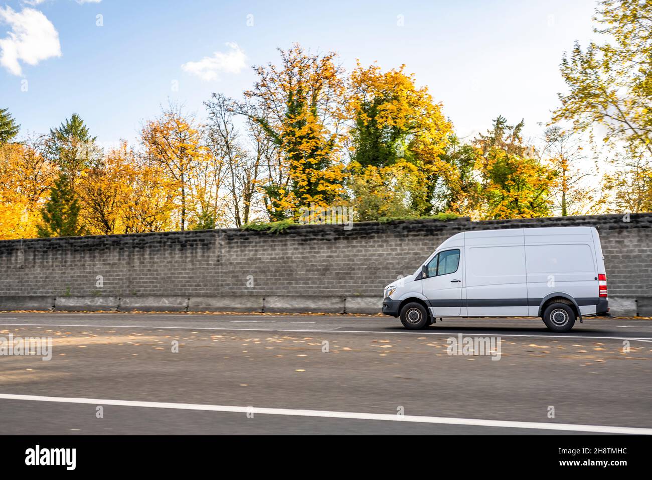 Commercial compact cargo small size white mini van delivering cargo to ...