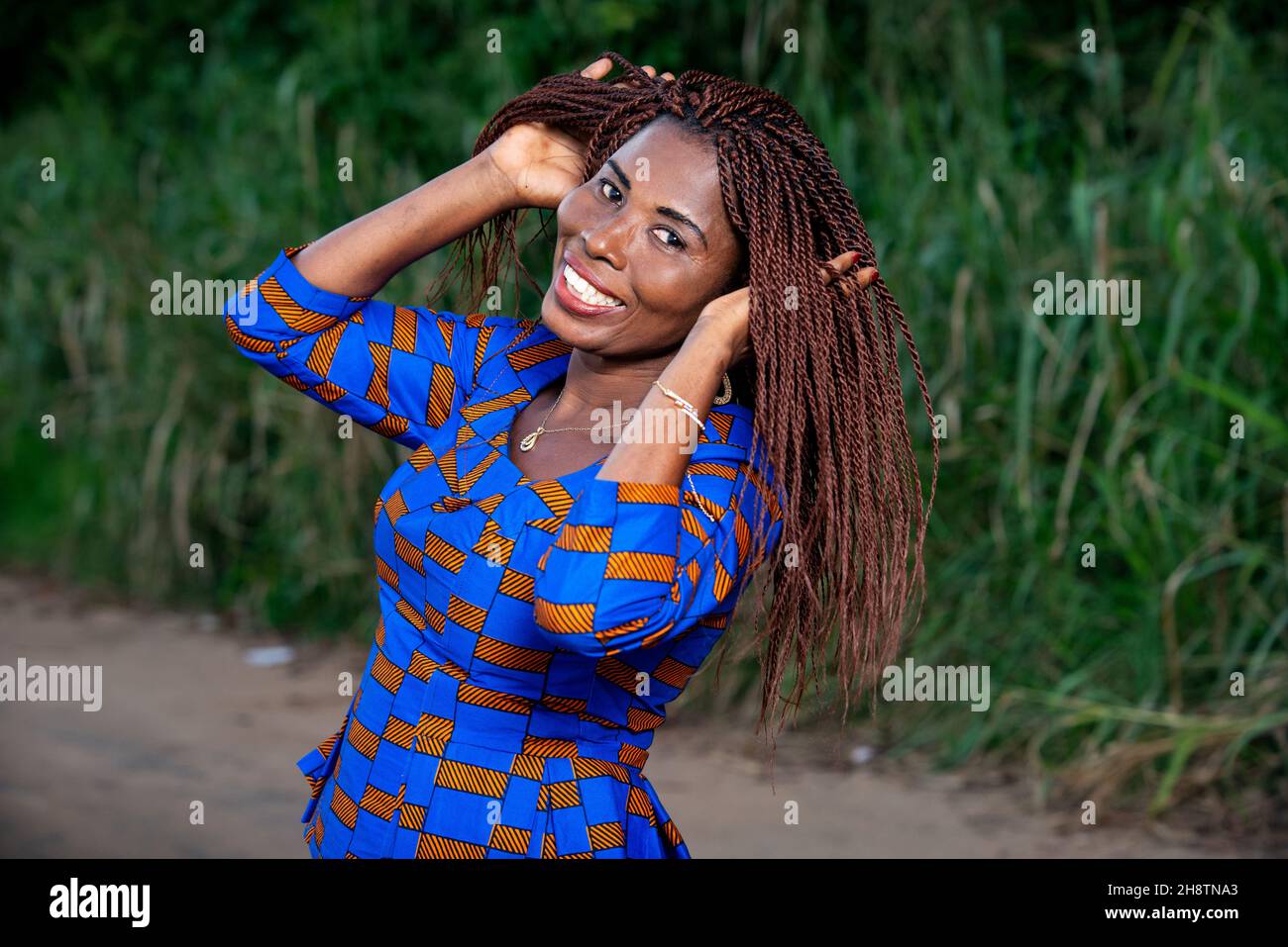 beautiful adult business woman playing with her braided hair in the ...