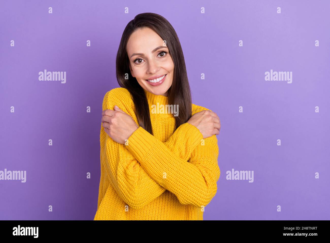 Photo Of Sweet Brunette Young Lady Hug Herself Wear Yellow Pullover