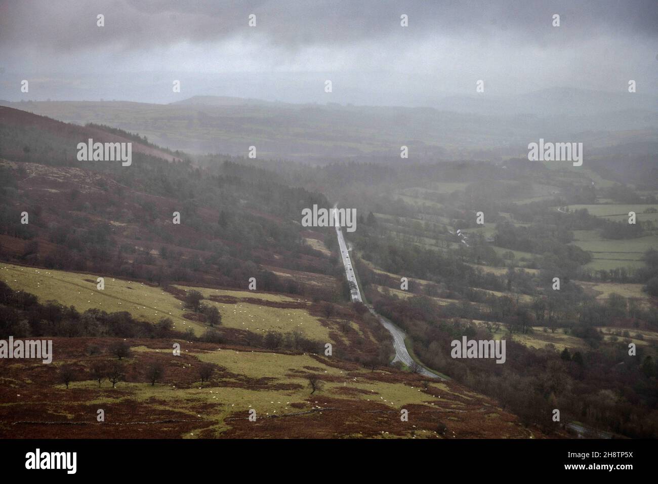 Rain clouds roll in across the landscape of the Brecon Beacons near Pen ...