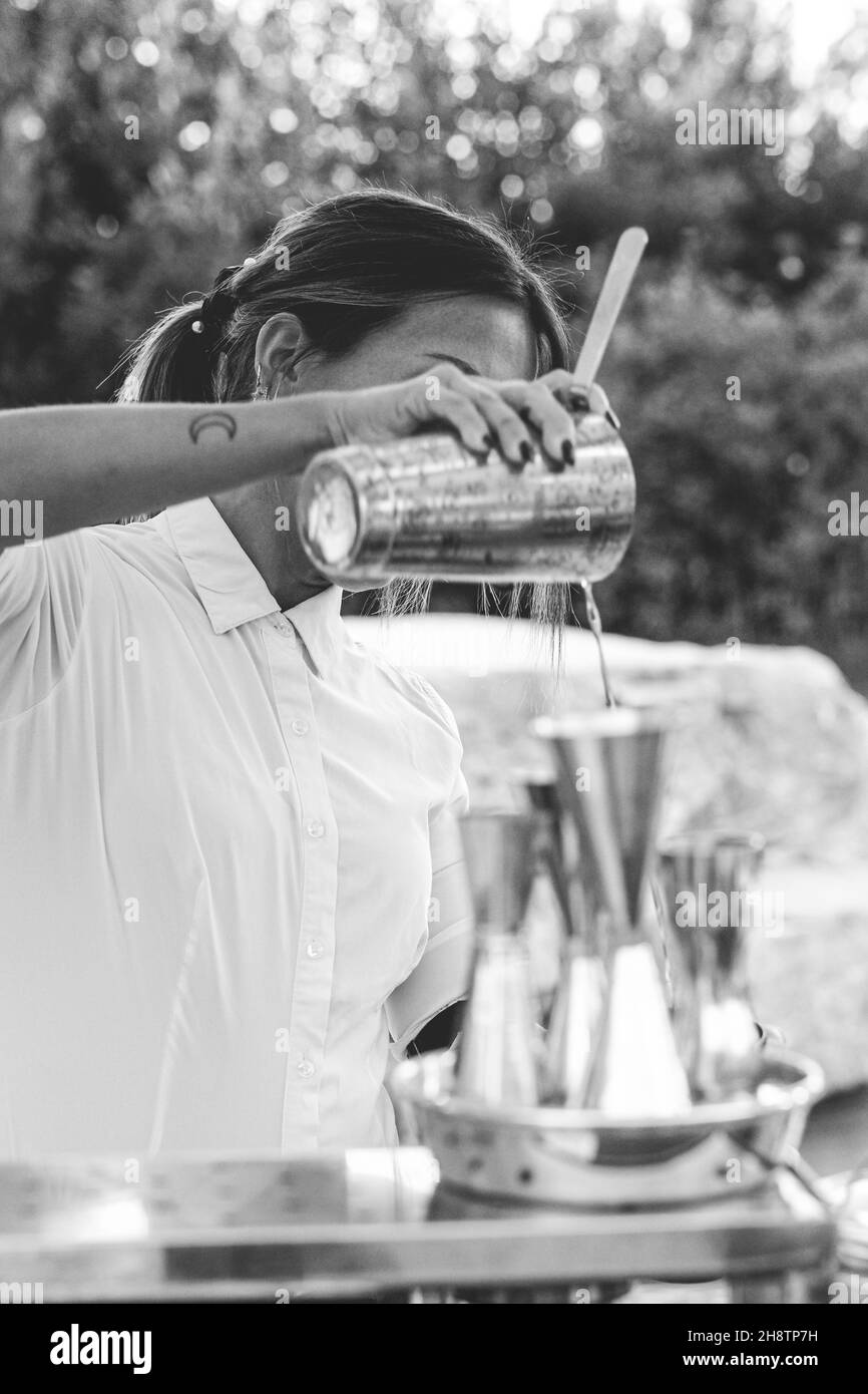 Vertical grayscale closeup of the barmaid making a cold cocktail Stock ...