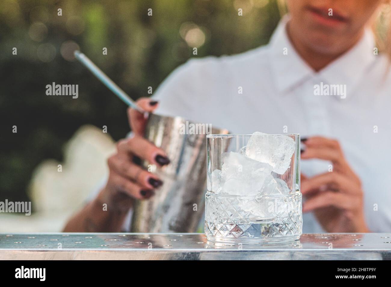 Closeup of the barmaid making a cold cocktail Stock Photo - Alamy
