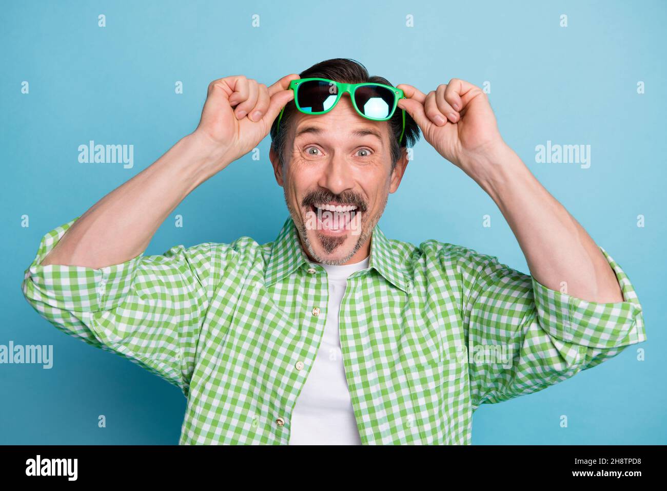 Portrait of attractive cheerful crazy funky man touching specs great ...