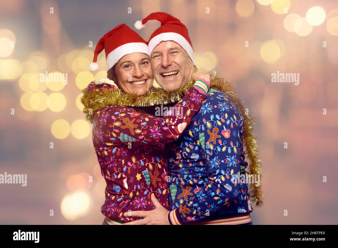 Joyful married couple celebrating Christmas together in festive red ...