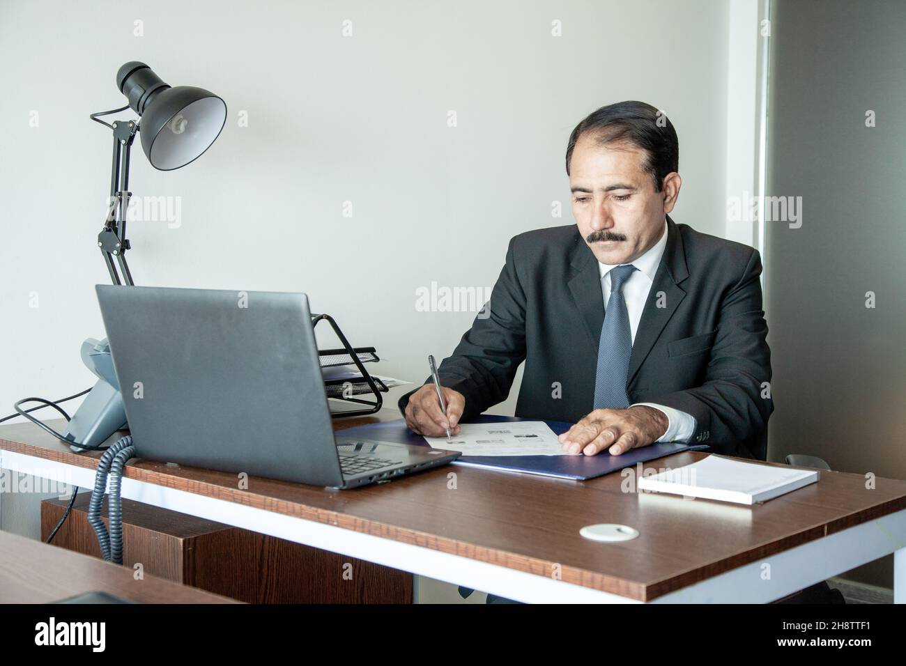 Middle age old business executive with moustache wearing suit and tie ...