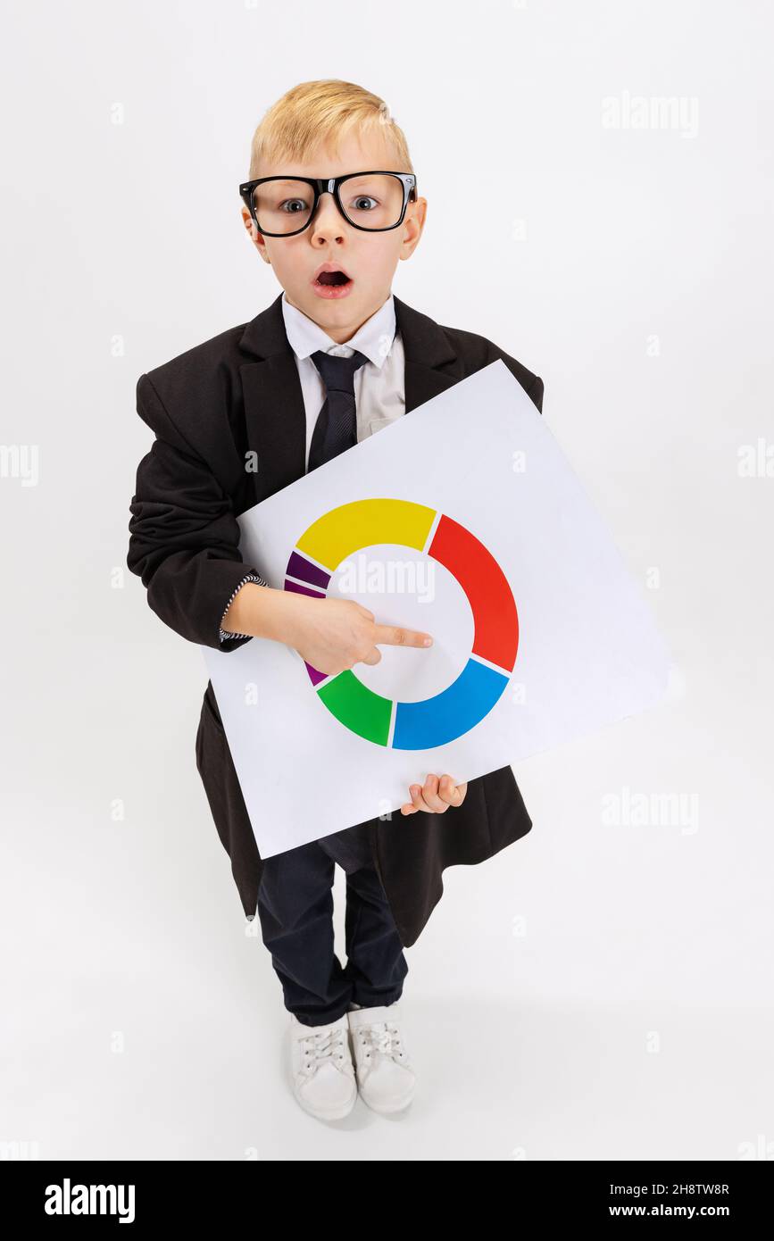 High angle view of cute little boy, kid businessman in huge suit jacket ...