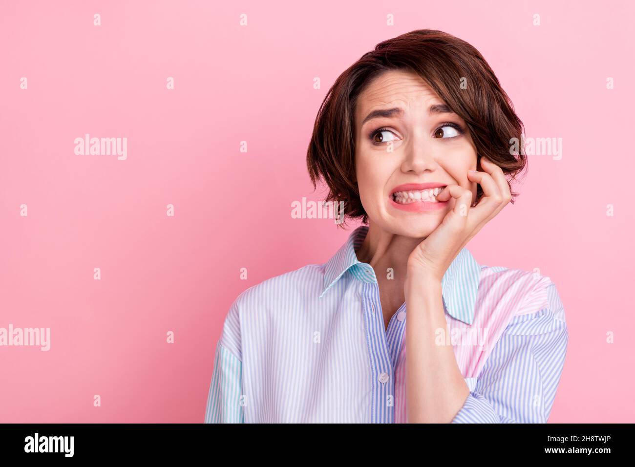 Photo of young woman bite fingers teeth worried scared nervous fail ...