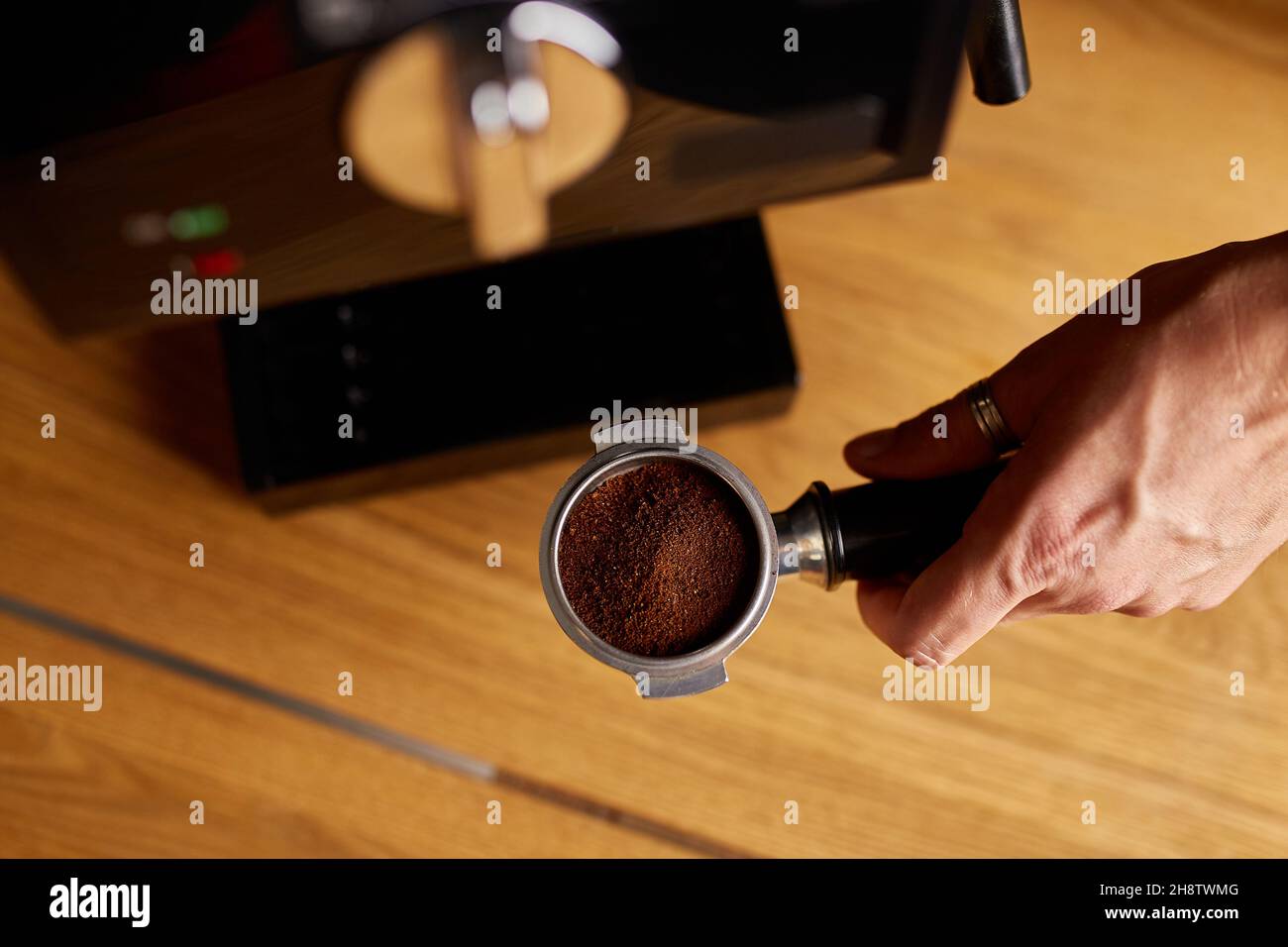 Female hands holding portafilter and making fresh aromatic coffee at ...