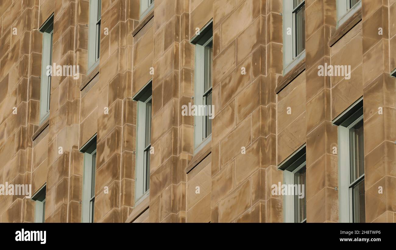 Brown building with narrow rectangular windows - background of a modern ...