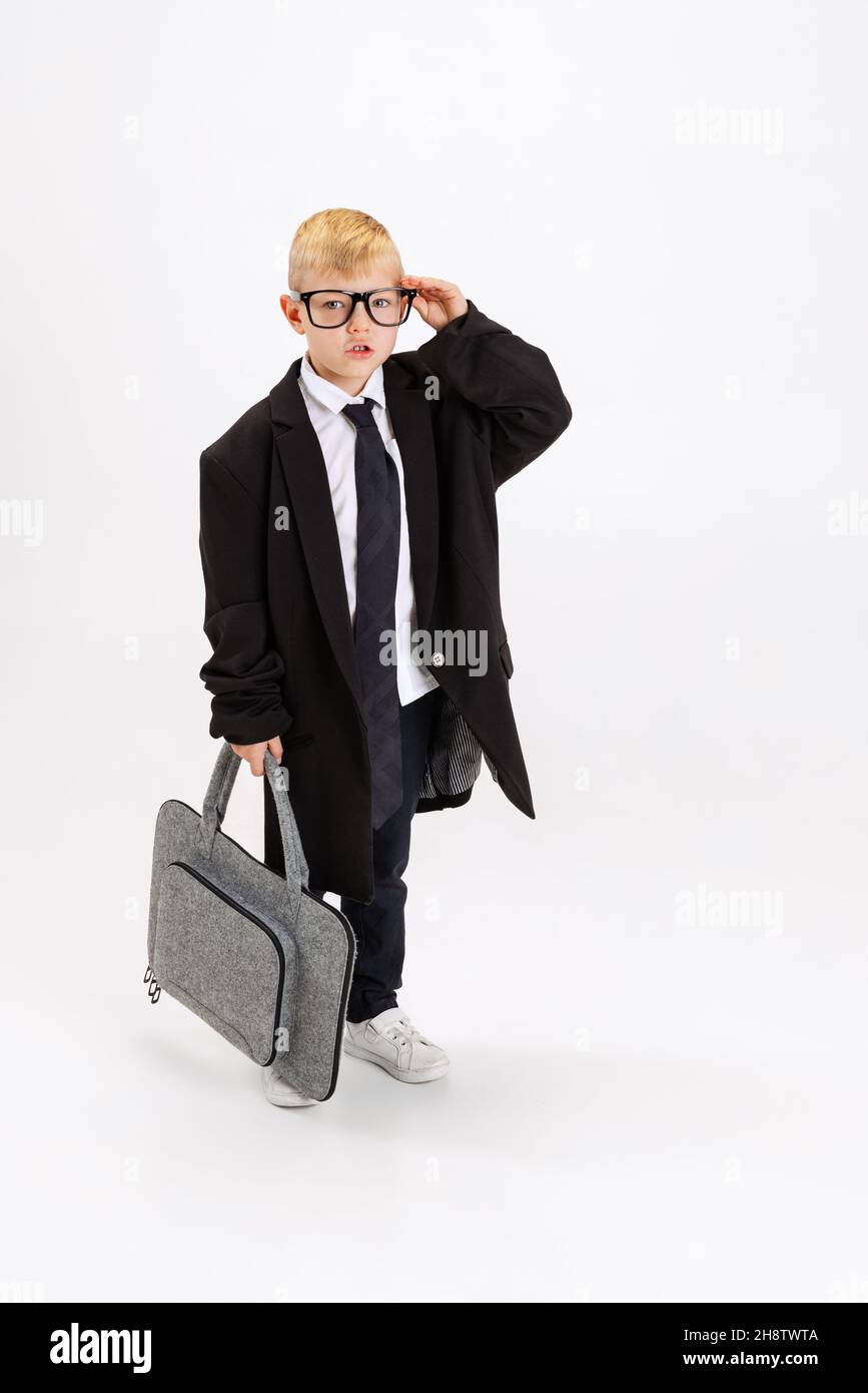 Close-up of cute little boy, kid businessman in huge jacket suit ...