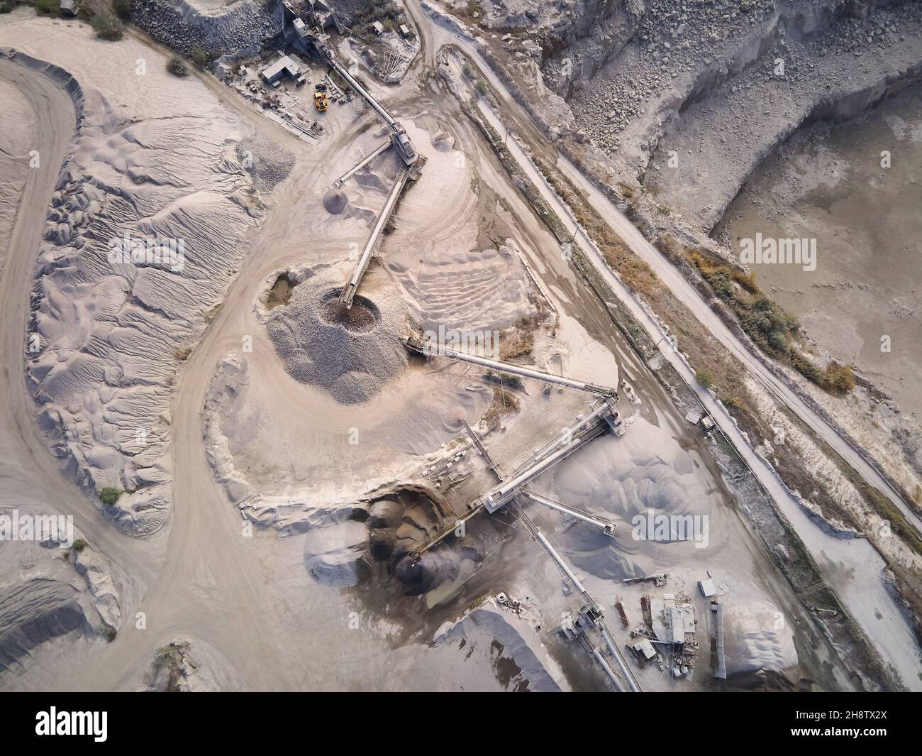 Aerial view of Slope operating granite quarry with mining equipment on ...