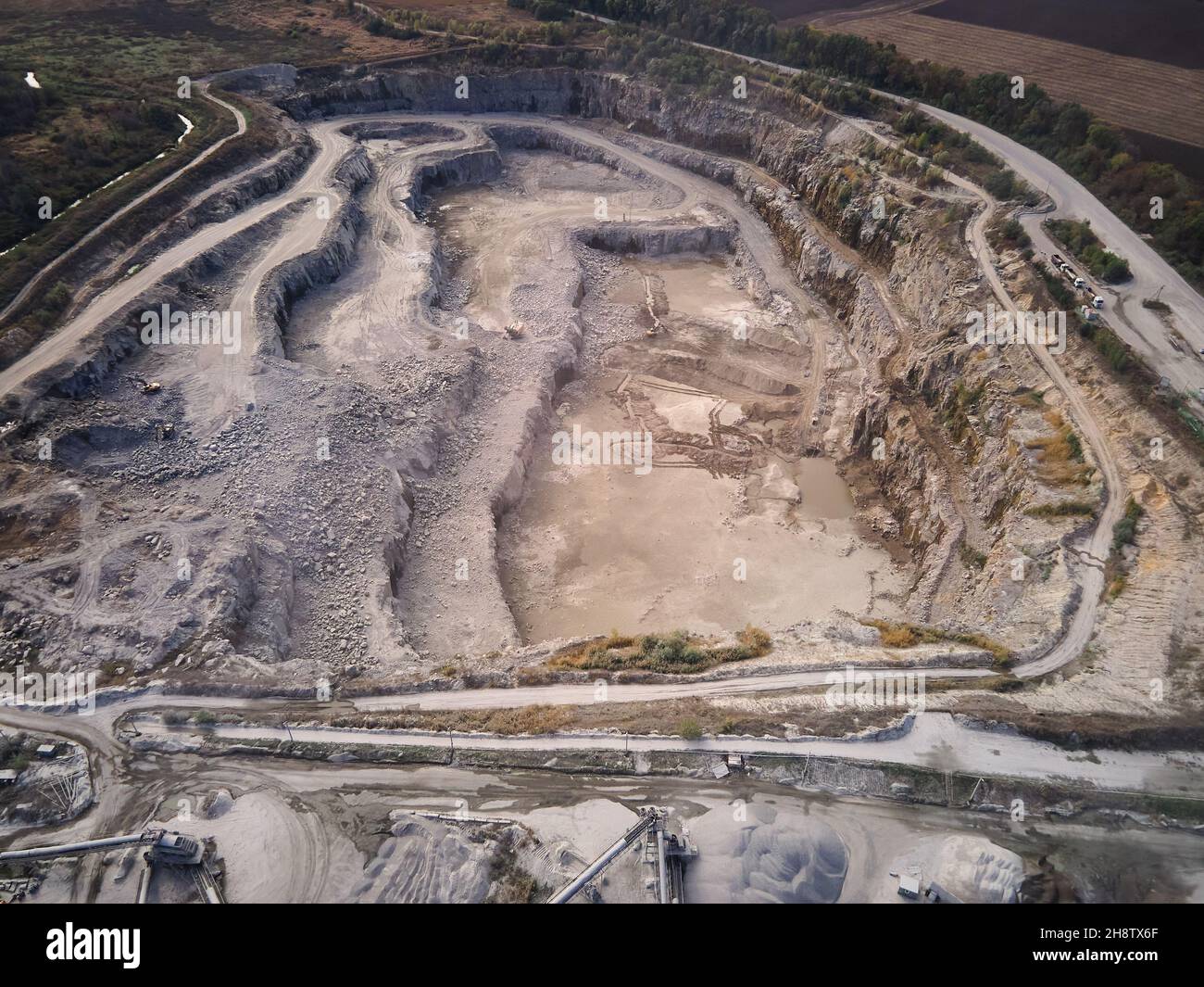 Aerial view of Slope operating granite quarry with mining equipment on ...