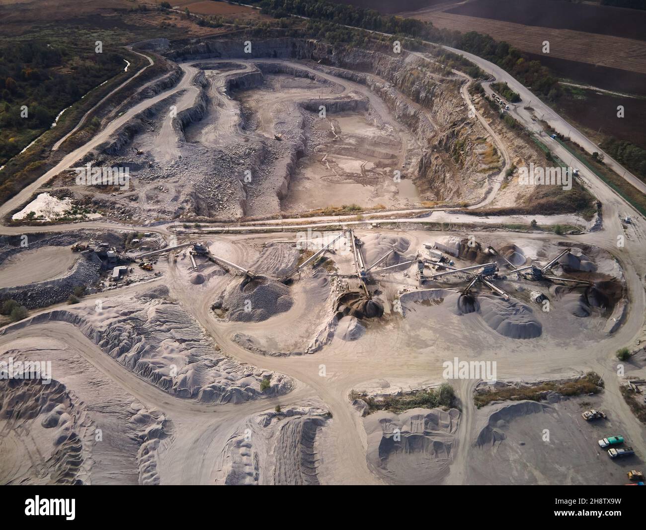 Aerial view of Slope operating granite quarry with mining equipment on ...