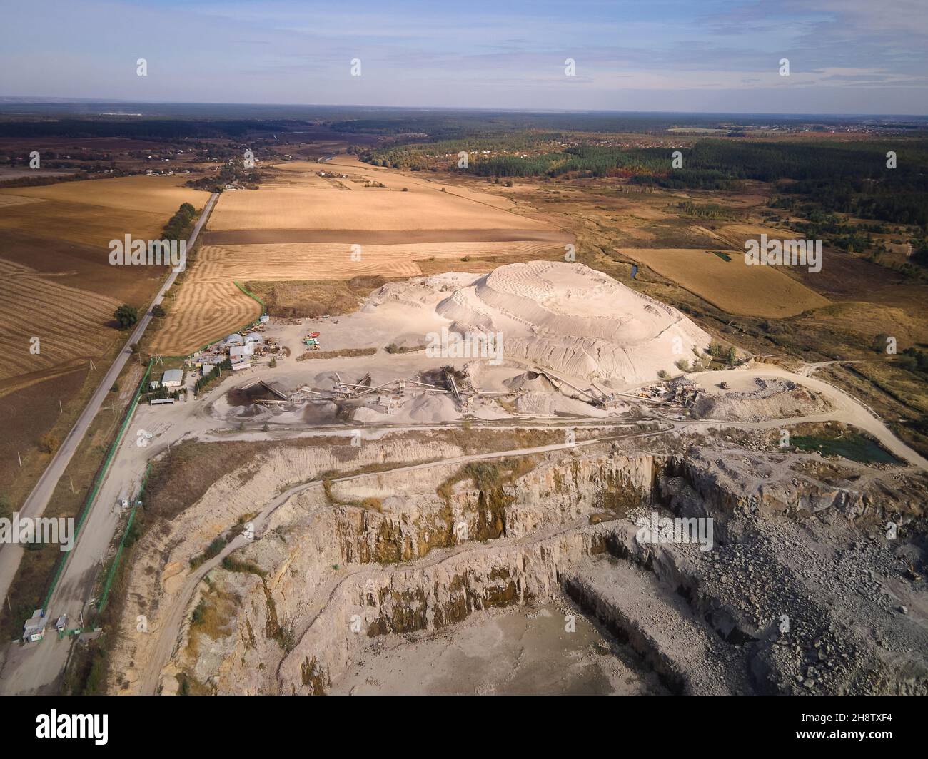 Aerial view of Slope operating granite quarry with mining equipment on ...