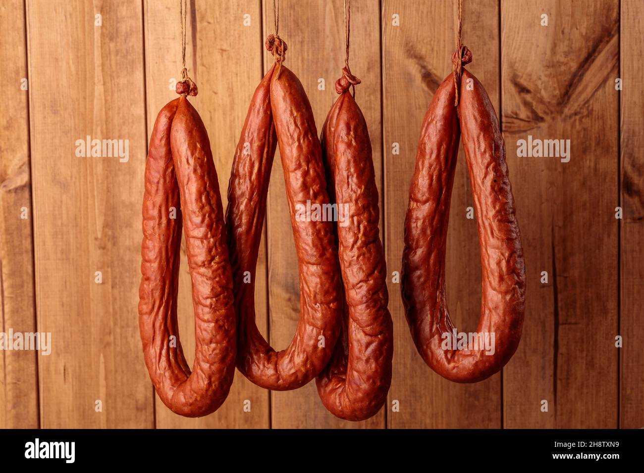tied fermented sausages rings hanging on rope Stock Photo - Alamy