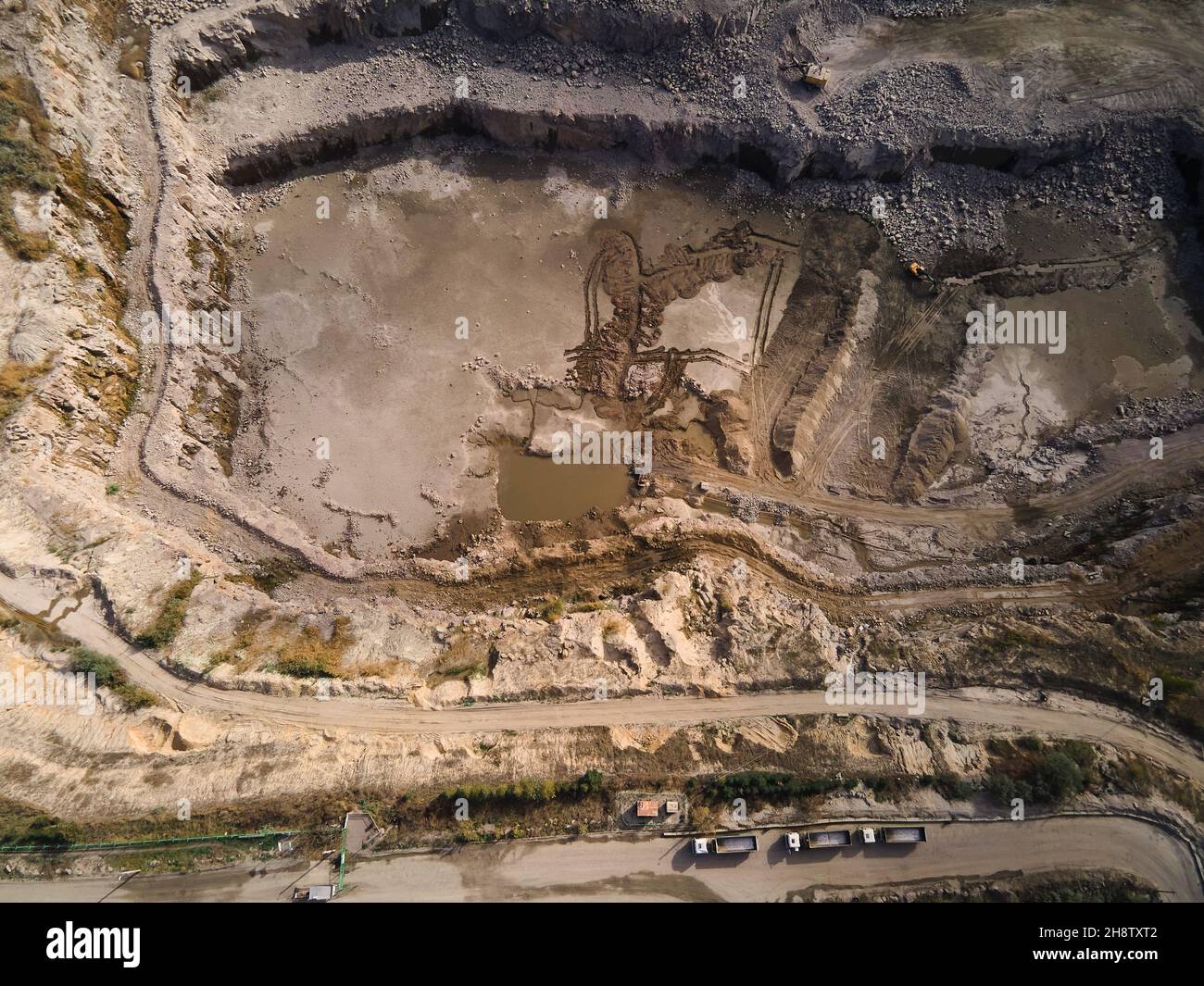 Aerial view of Slope operating granite quarry with mining equipment on ...