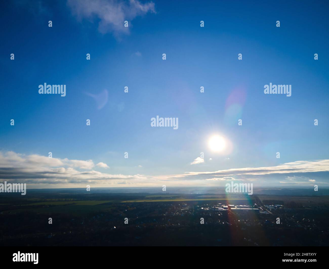 Bright sun light, sunbeams, flares shining through sunrise clouds ...
