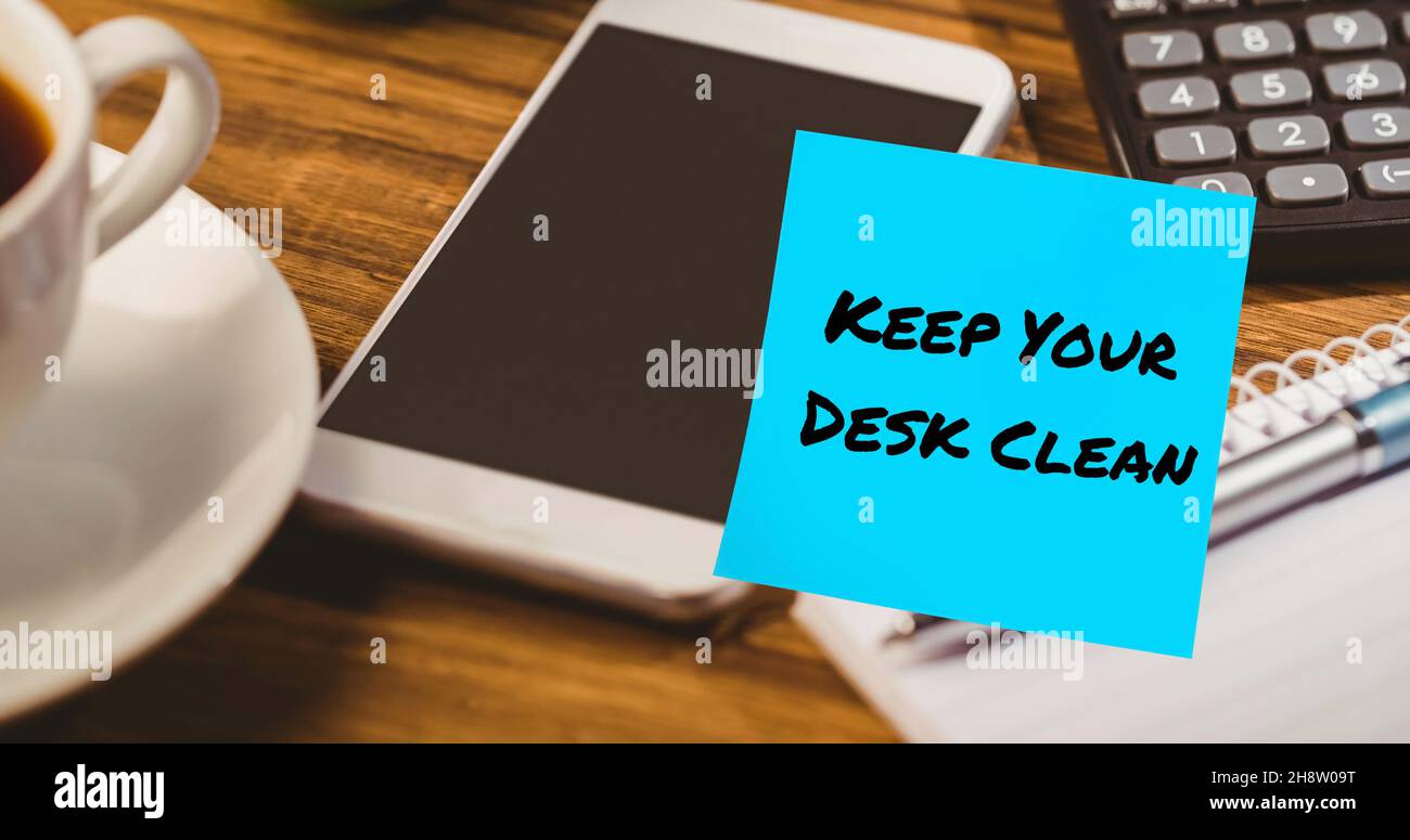 Image of keep your desk clean text on memo note over smartphone on desk ...