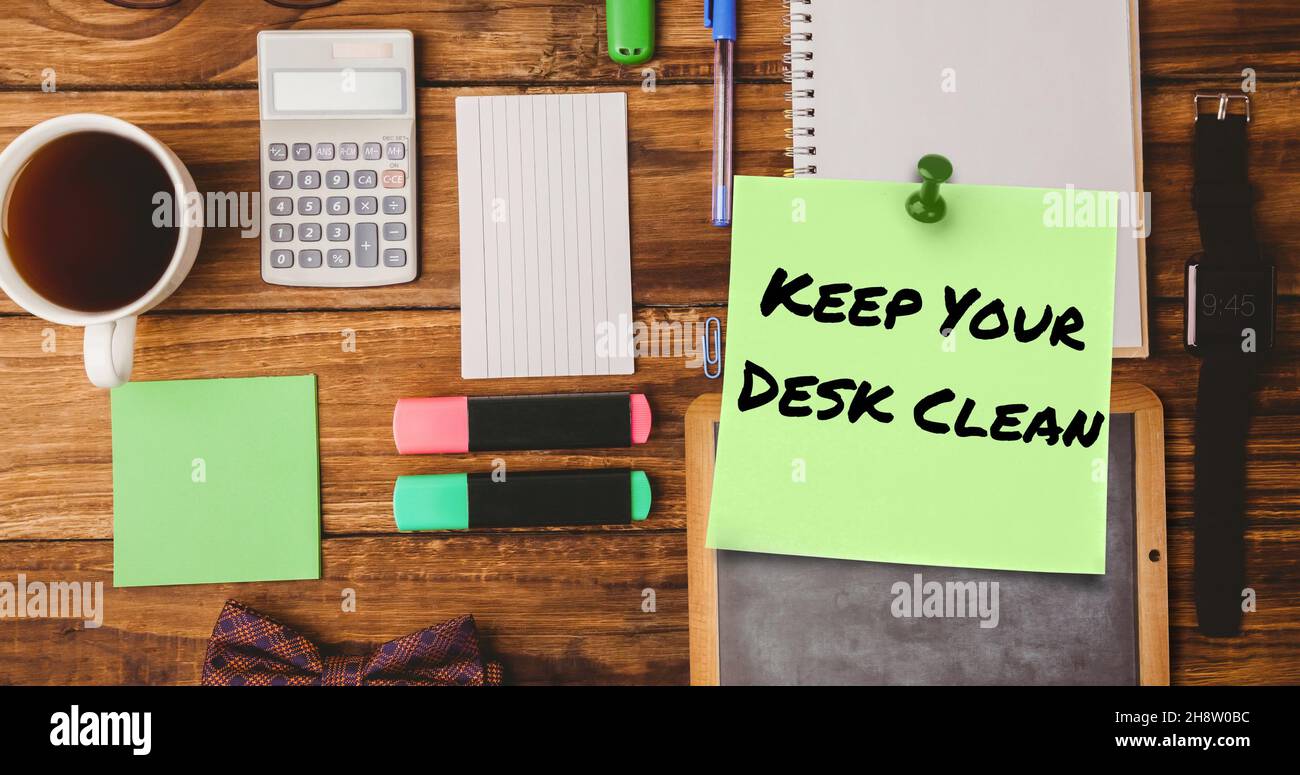 Image of keep your desk clean text on memo note over office items on ...