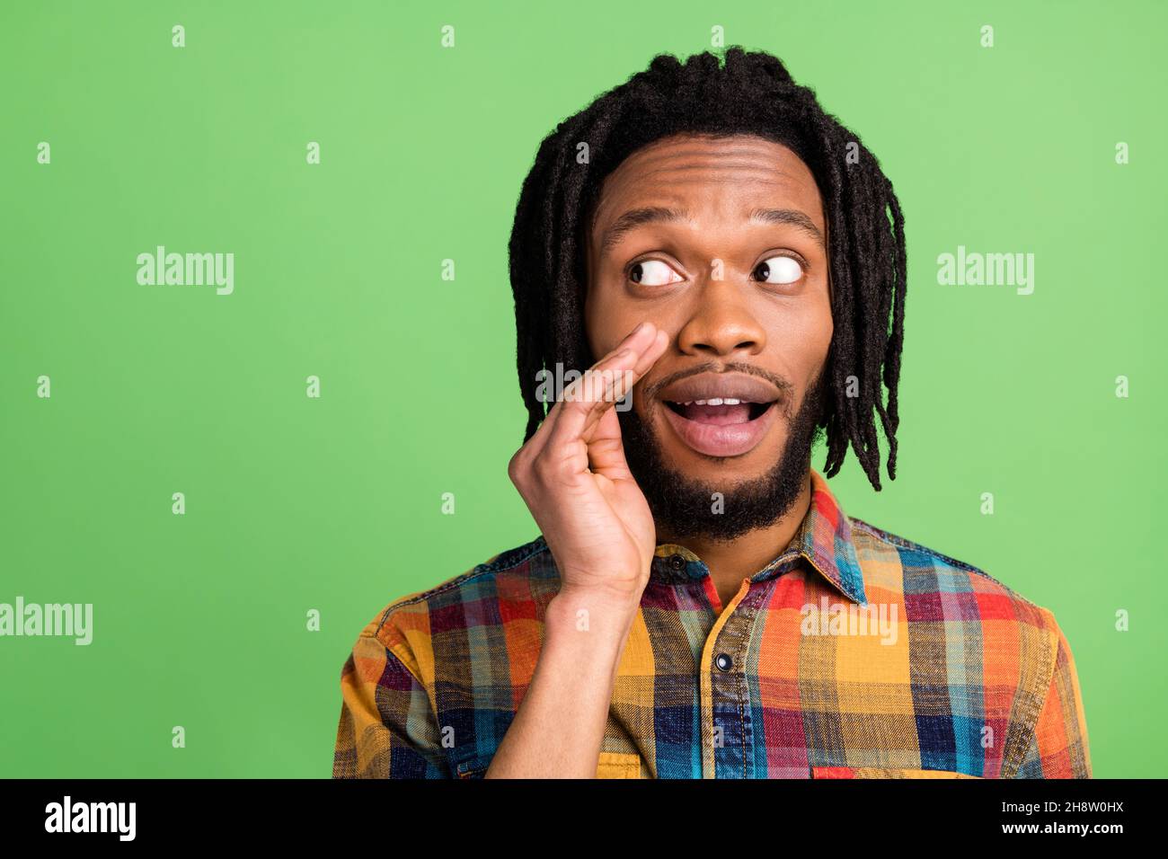 Photo of charming tricky dark skin guy dressed checkered shirt arm lips ...