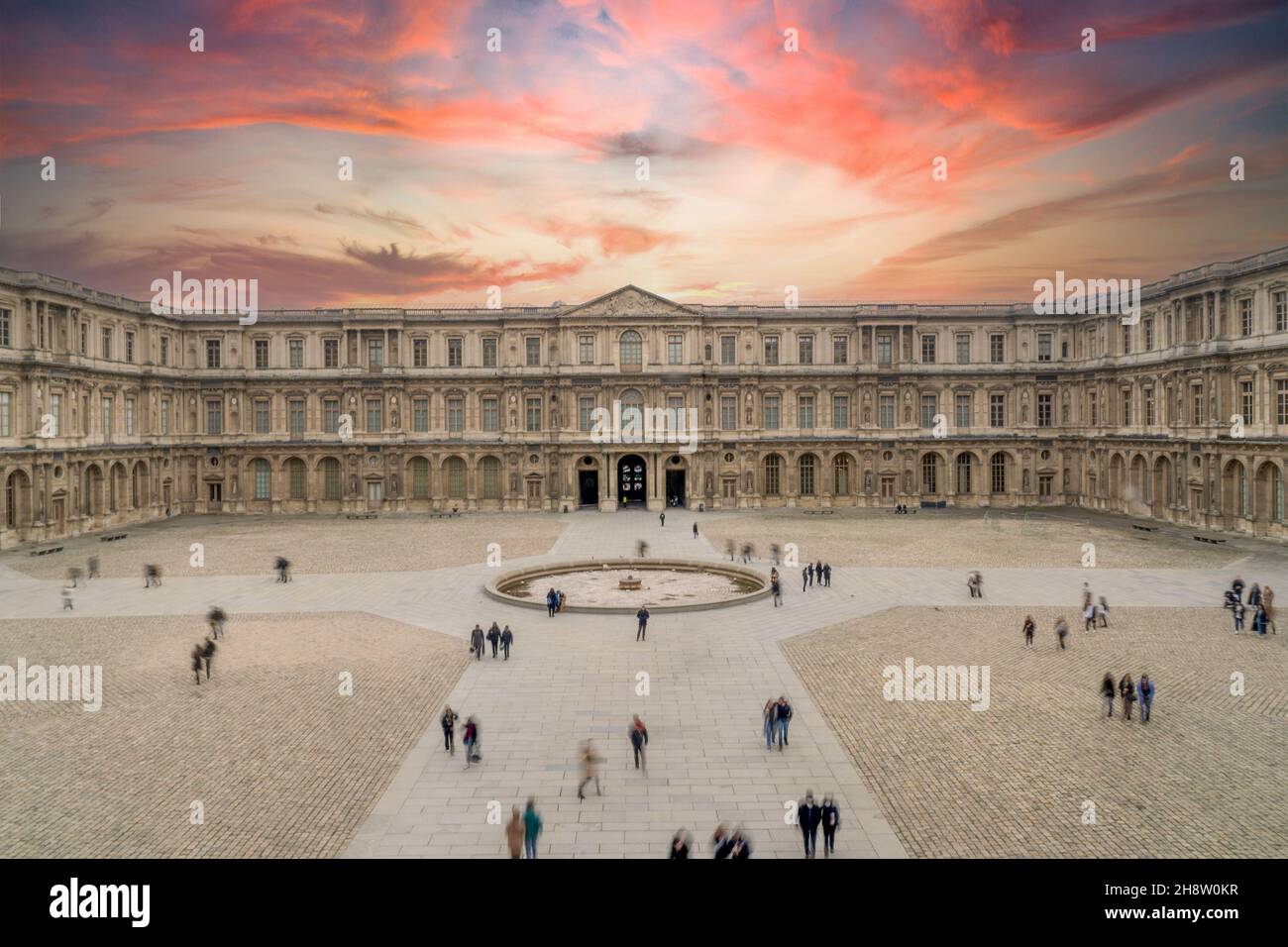 louvre museum exterior with tourist walking at sunset in november Stock ...