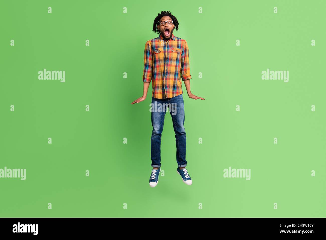 Photo of crazy astonished african guy jump scream open mouth wear plaid ...