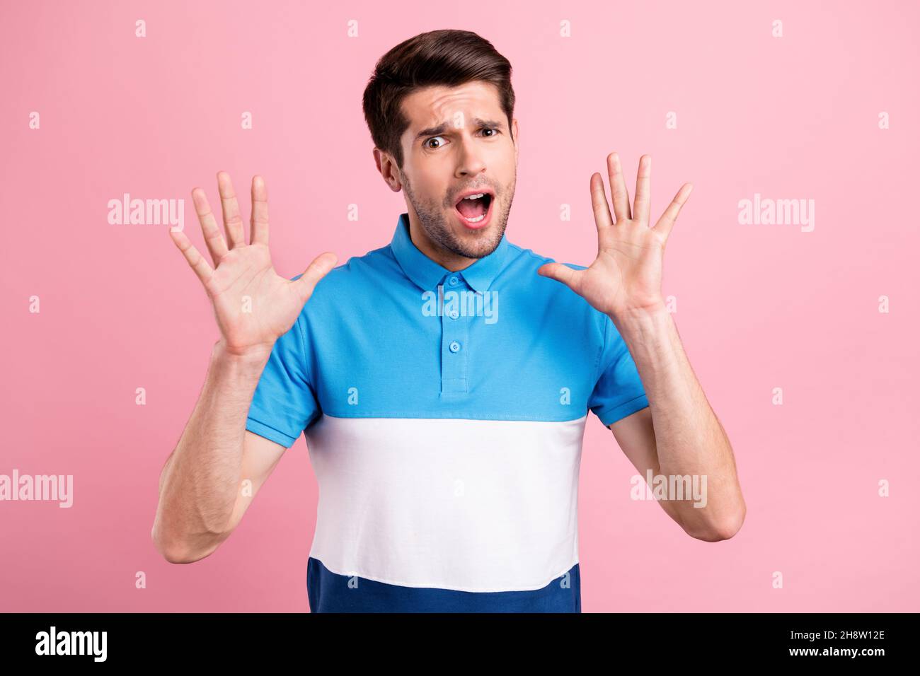 Photo of young serious displeased male showing stop sign refuse reject ...