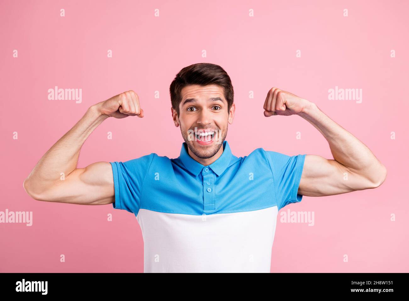 Portrait of young good mood excited male showing muscles fit body ...