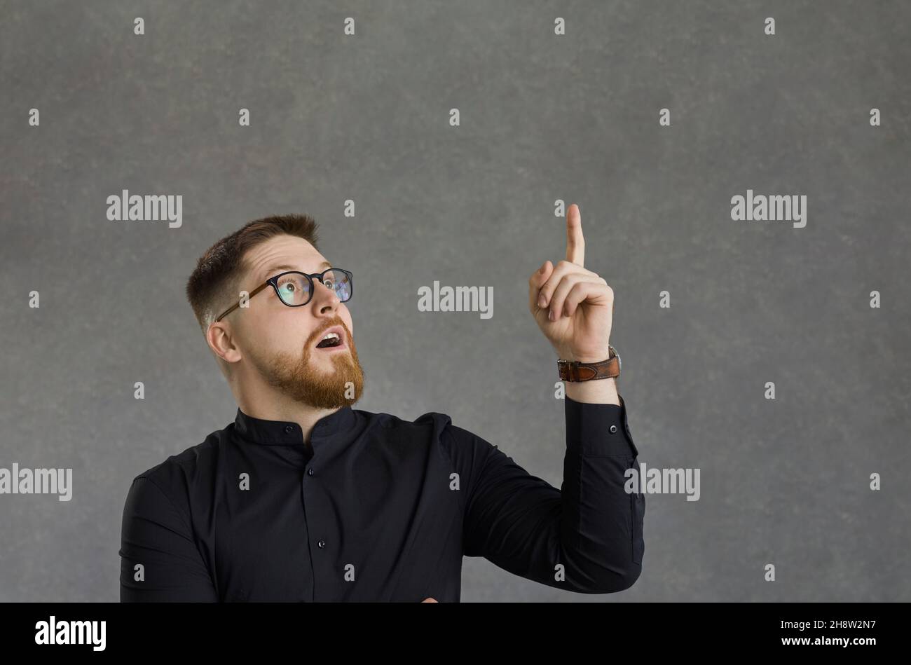 Smart excited caucasian man pointing finger up having great idea studio ...