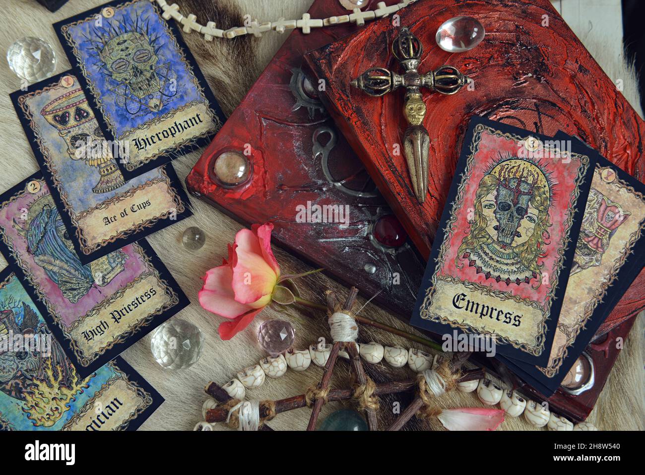 Still life with magic book of spells, tarot cards and ritual objects on ...