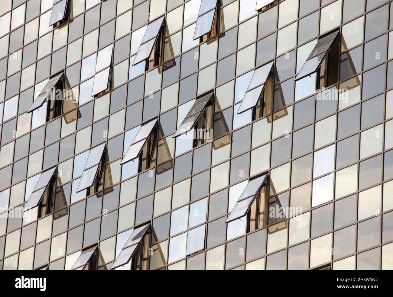 Detail picture of a glass facade with open windows Stock Photo - Alamy