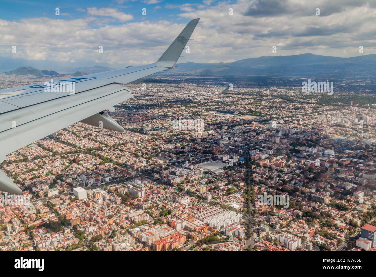 MEXICO CITY, MEXICO - OCTOBER 8, 2016: Wing of an airplane flying over ...