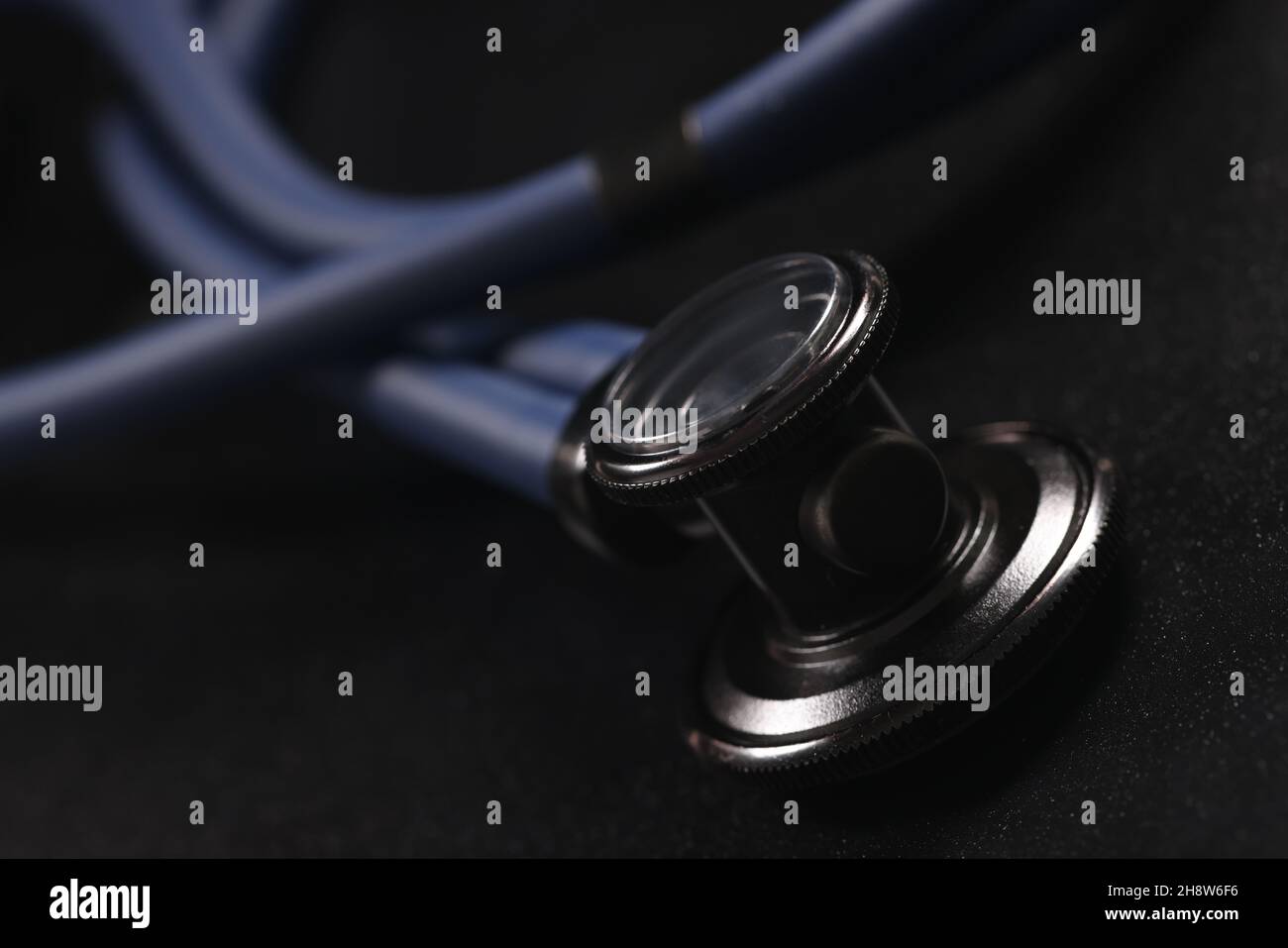 Head of medical stethoscope lying on black background closeup Stock ...