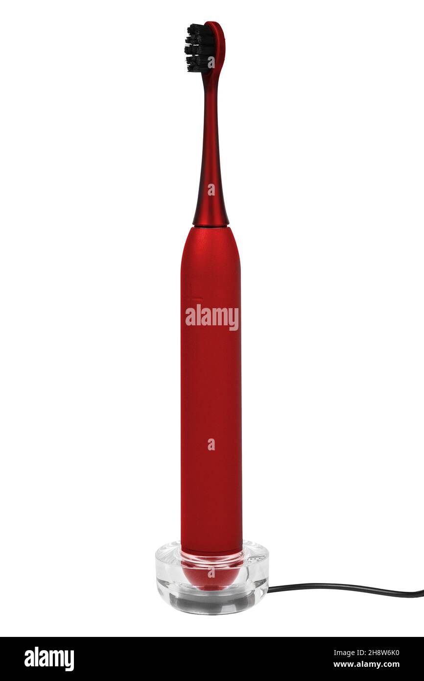 Red modern electric toothbrush gray color on a stand with a charger ...