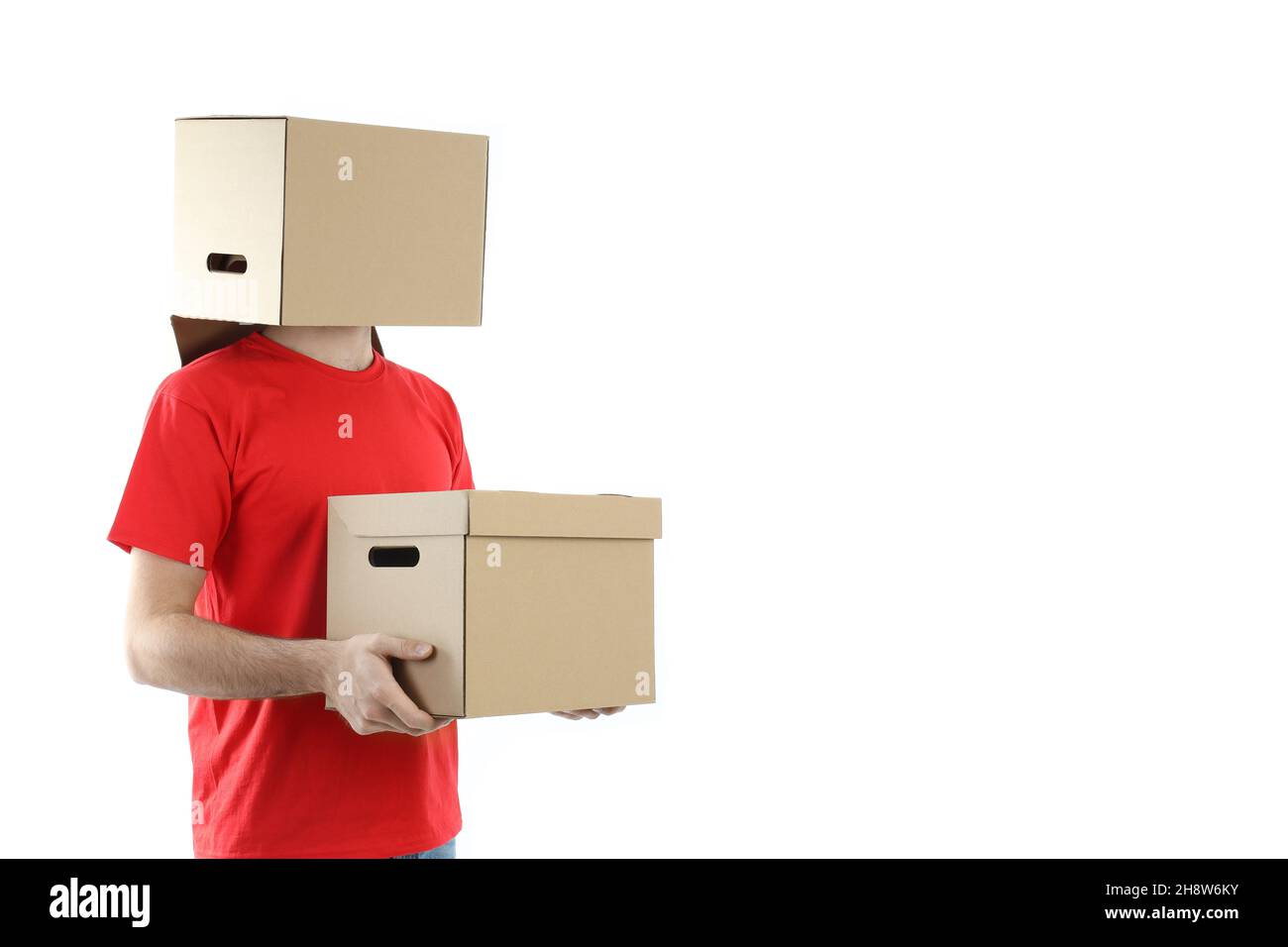 Delivery man with a box on his head and in the hands, isolated on white ...