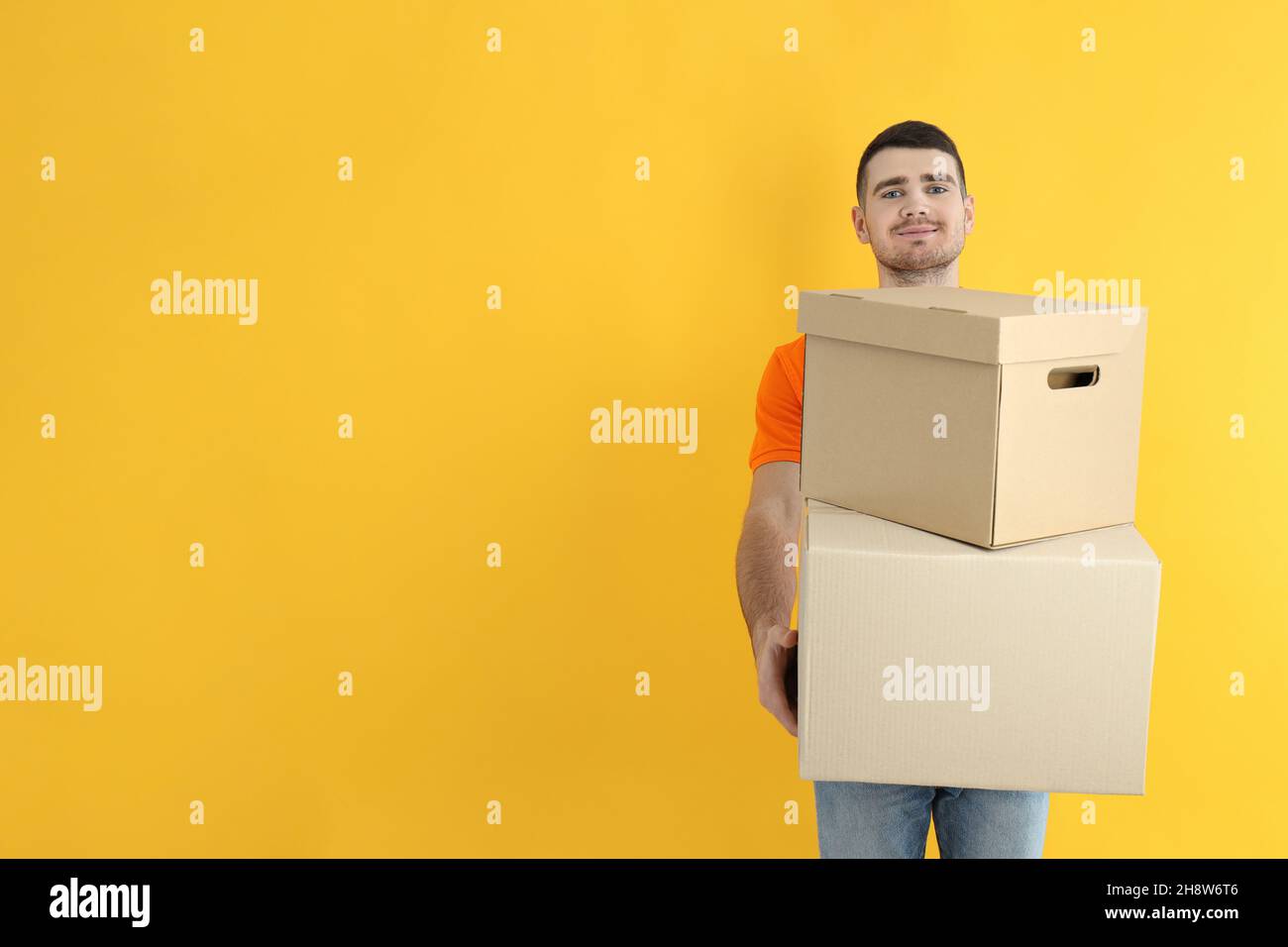 Yellow delivery hand cardboard boxes hi-res stock photography and ...