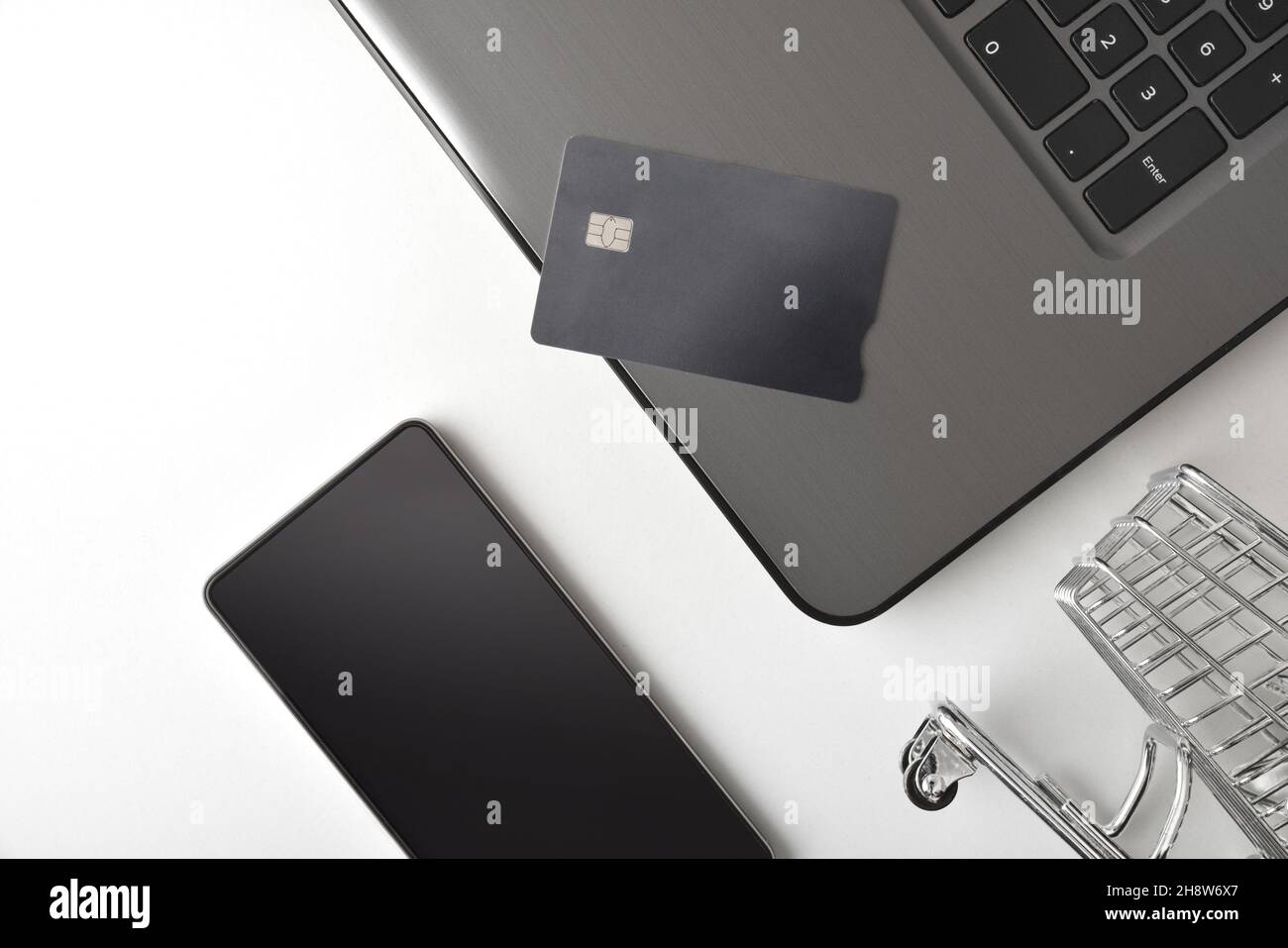 Online purchases concept with shopping cart credit card and devices on ...