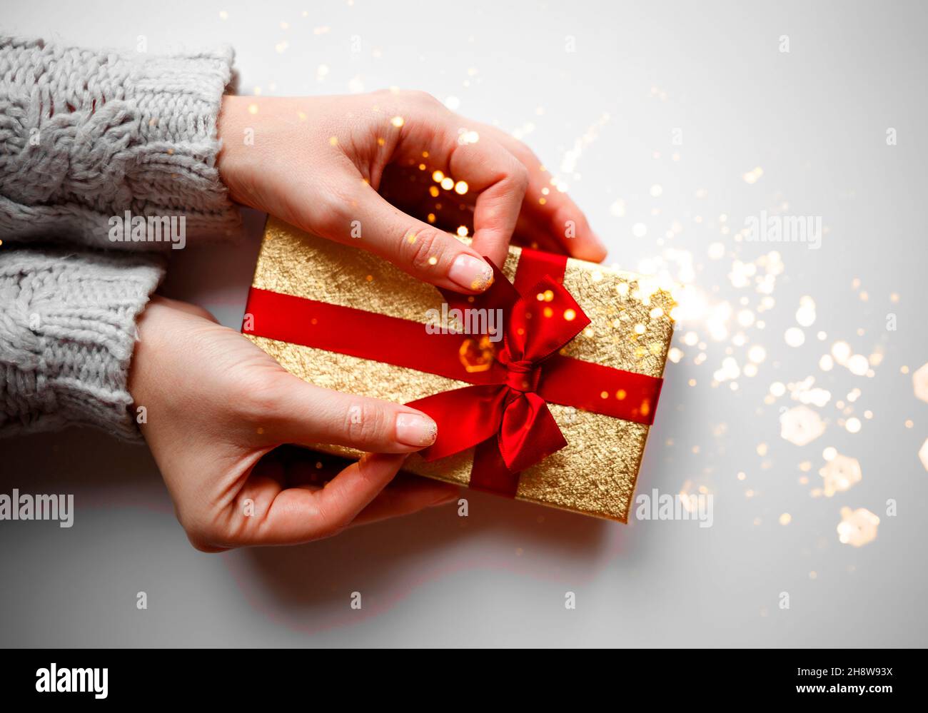 hands hold a gift on a white background Stock Photo - Alamy