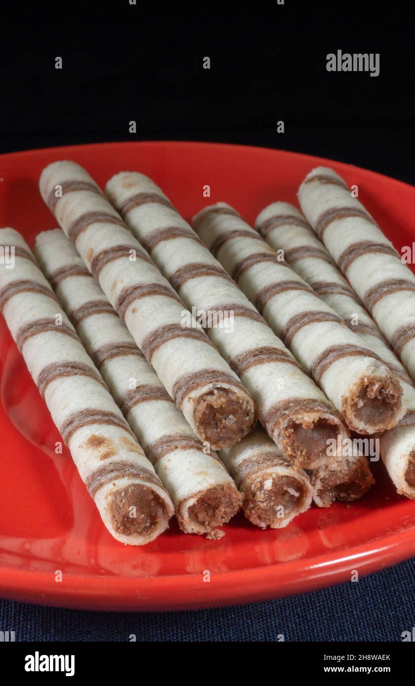 The Sweet sticks with stuffing in red plate on black background ...