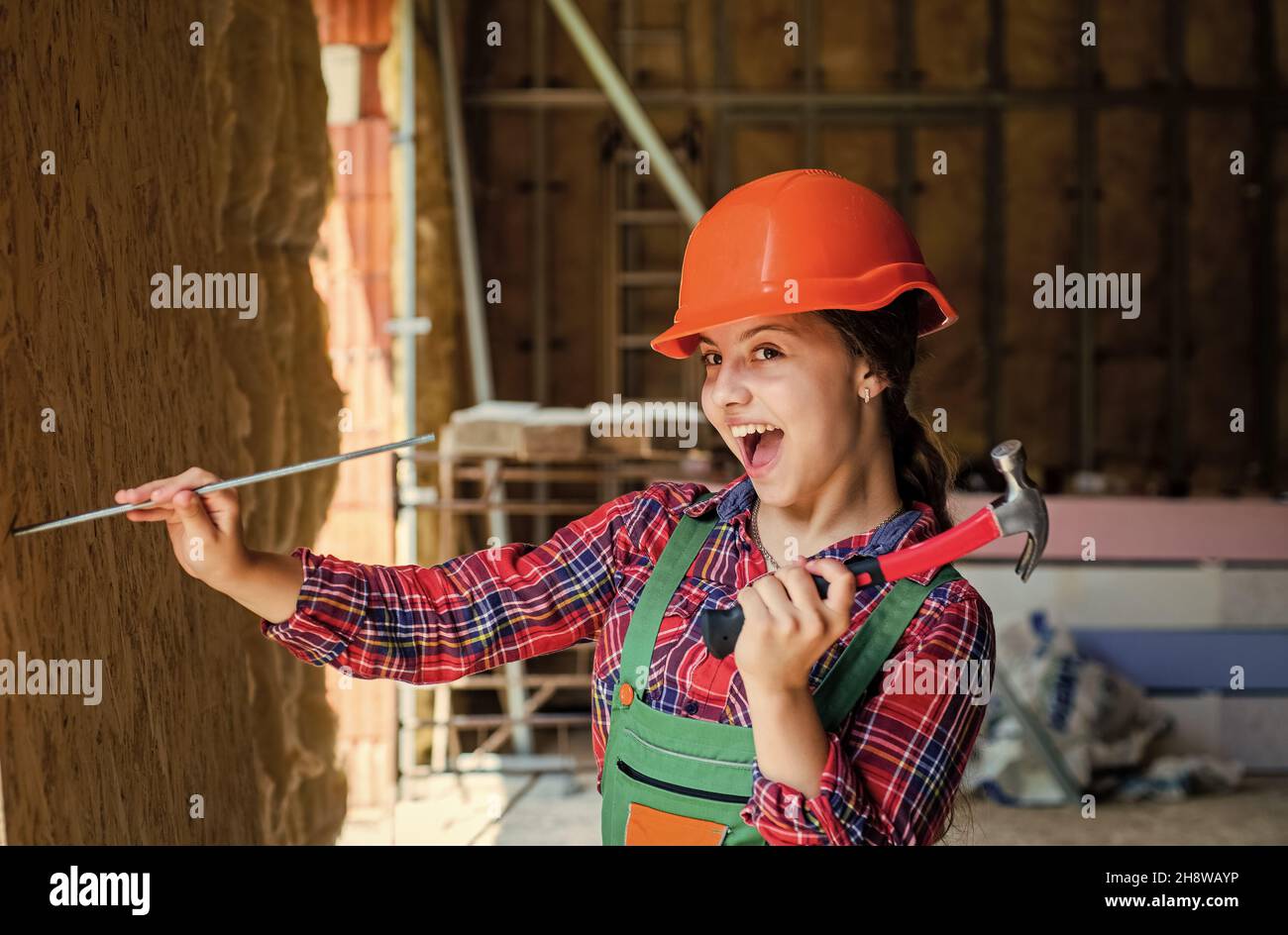 Childrens creativity. kid wear helmet on construction site. teen girl ...