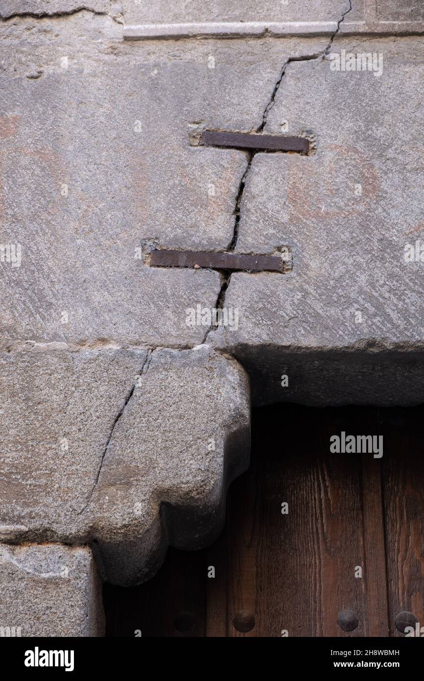 Metal staple to repair a crack in a stone wall. Vertical image Stock ...