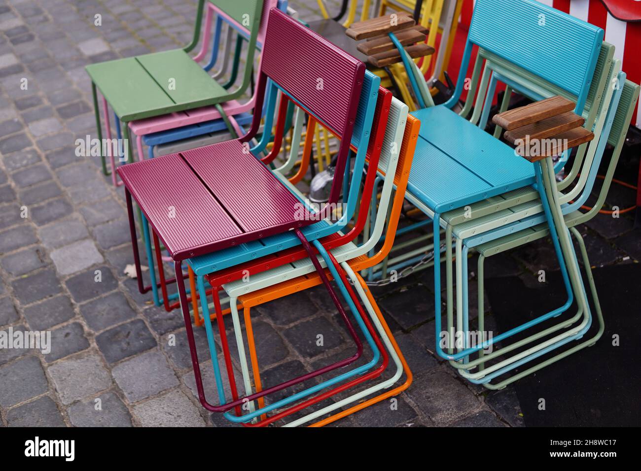 Closeup of the colorful chairs stacked on top of each other Stock Photo ...