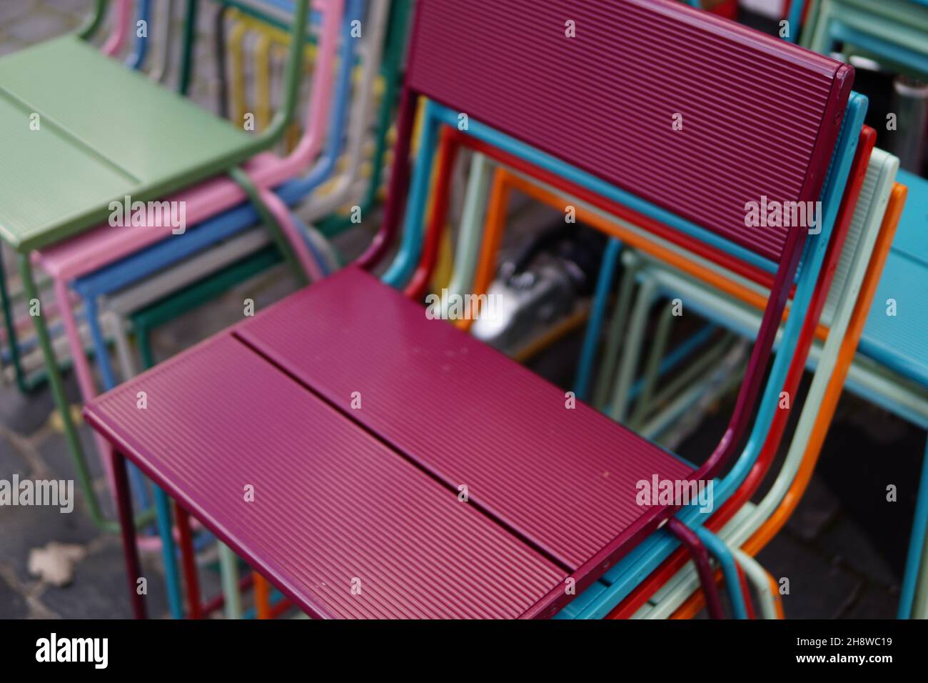 Closeup of the colorful chairs stacked on top of each other Stock Photo ...