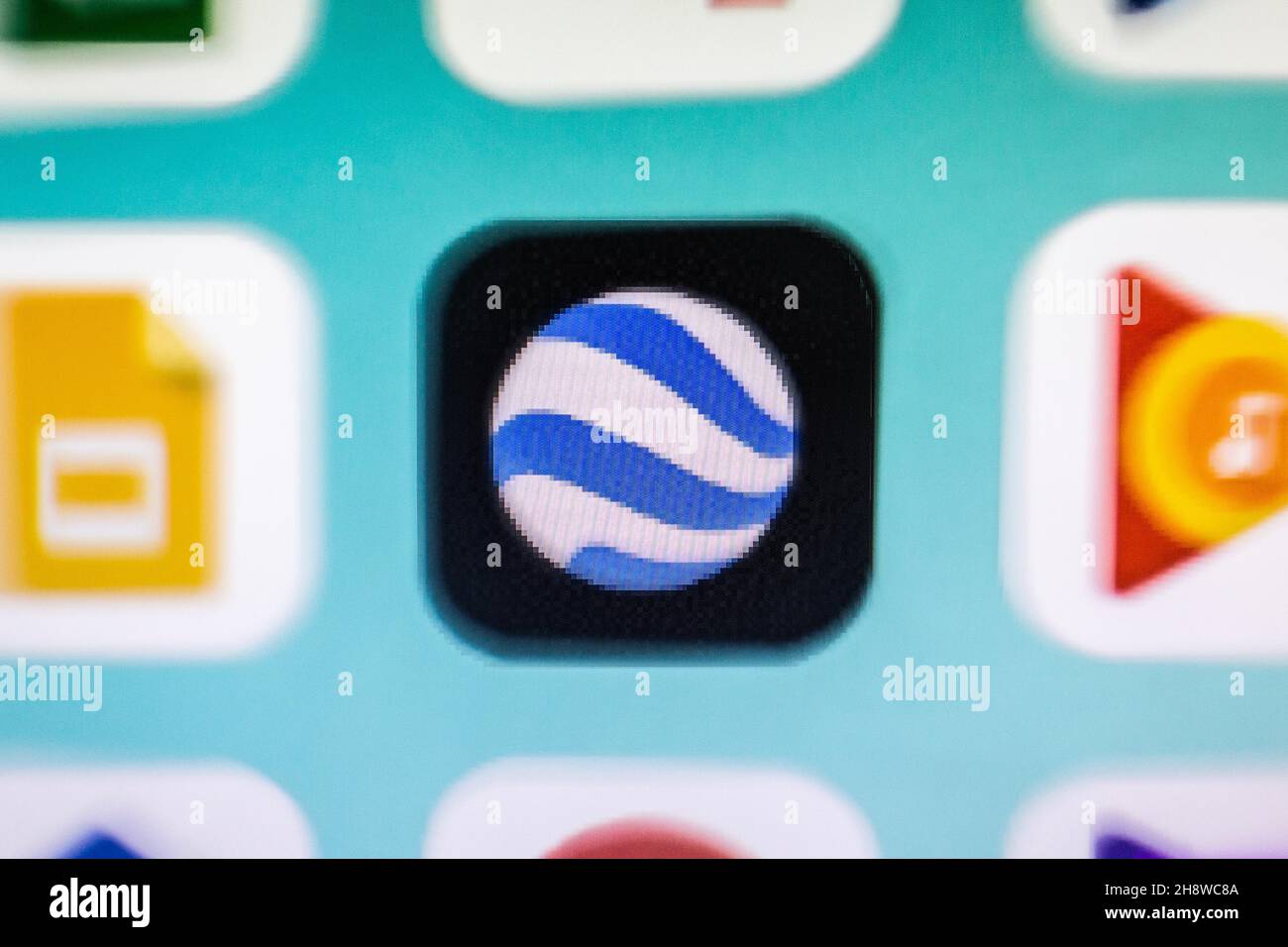 In this photo illustration a close-up of a Google Earth app icon seen ...